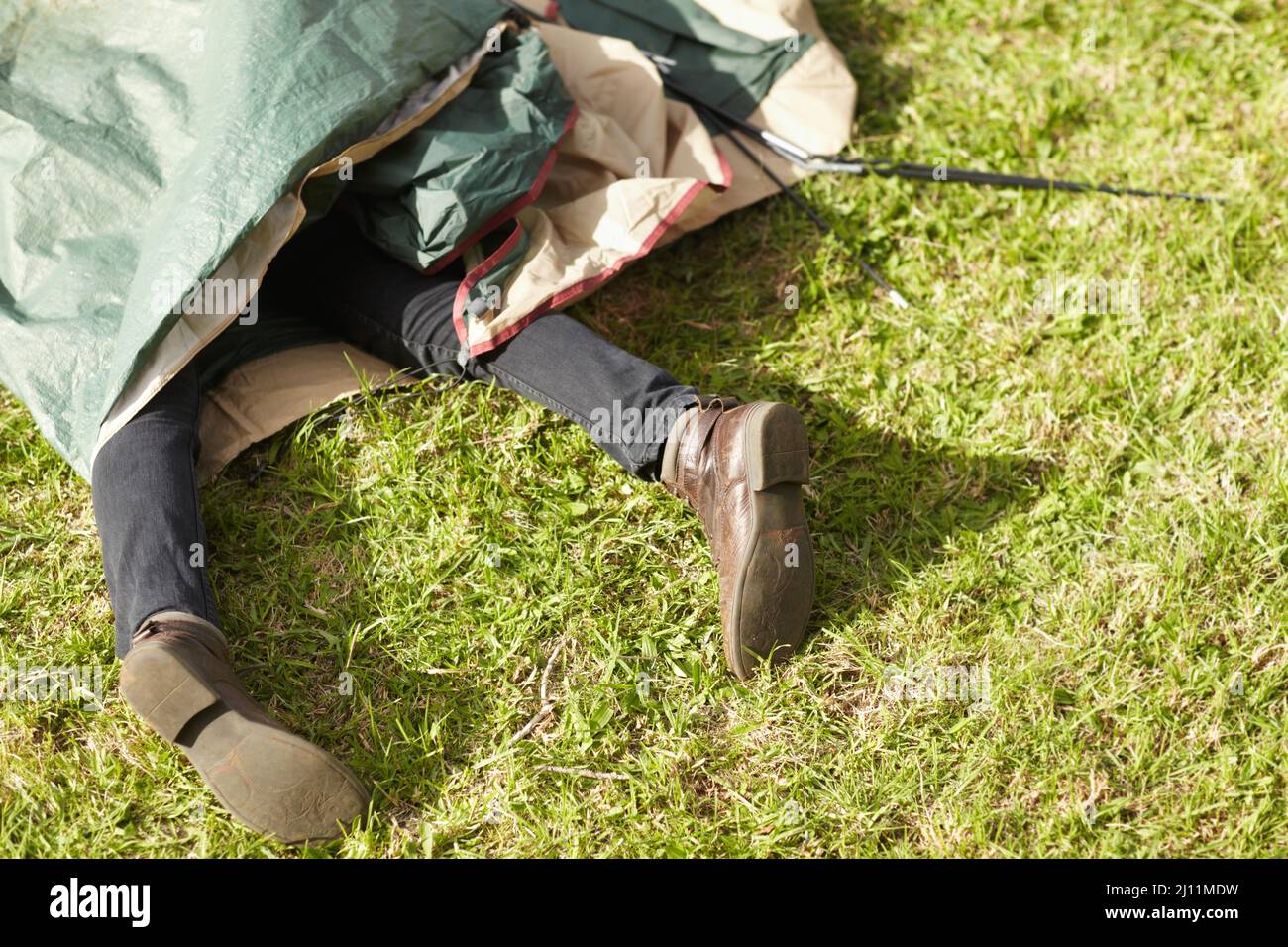Camping disaster. Cropped view of a mans legs while trapped beneath a ...