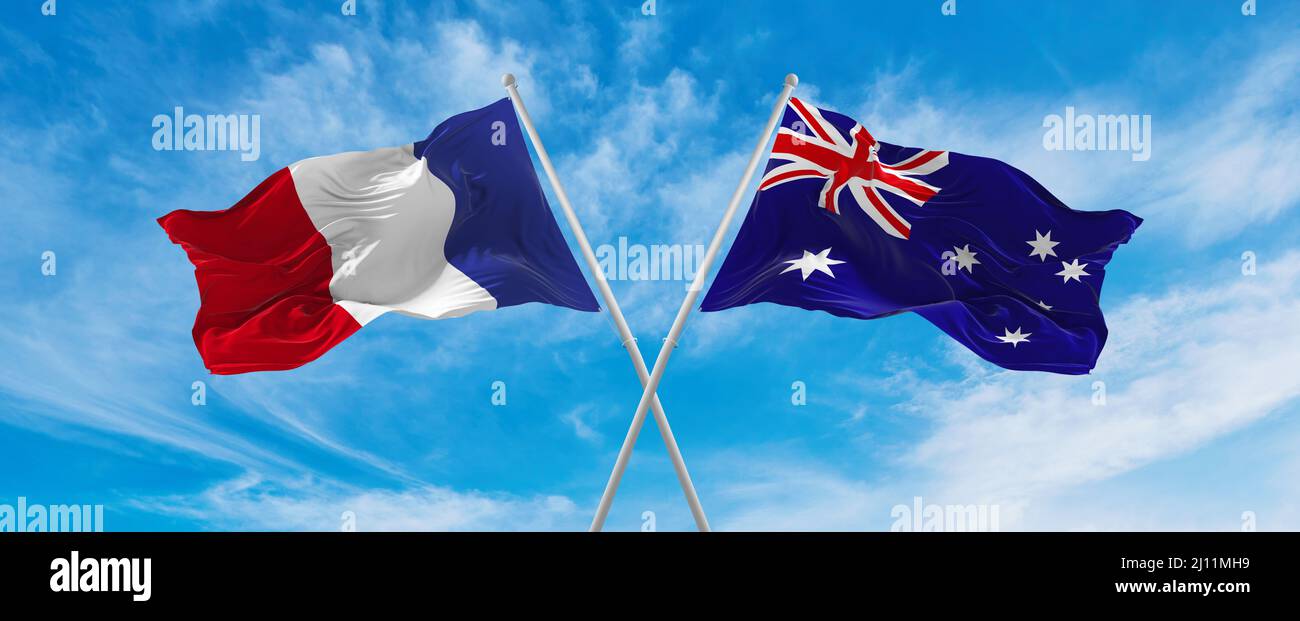 crossed national flags of France and Australia flag waving in the wind ...