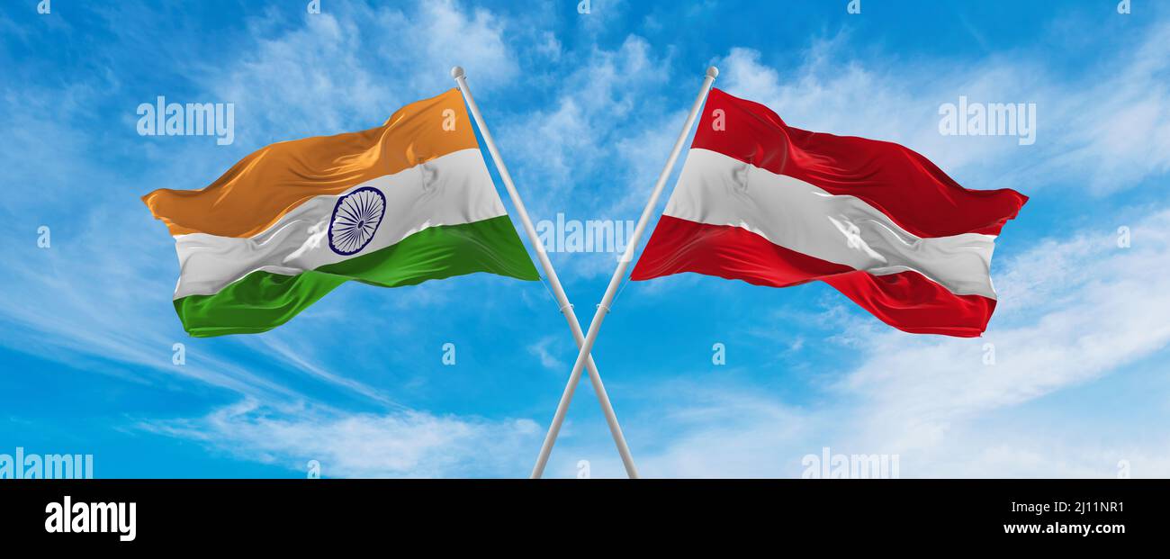 crossed national flags of India and Austria flag waving in the wind at ...