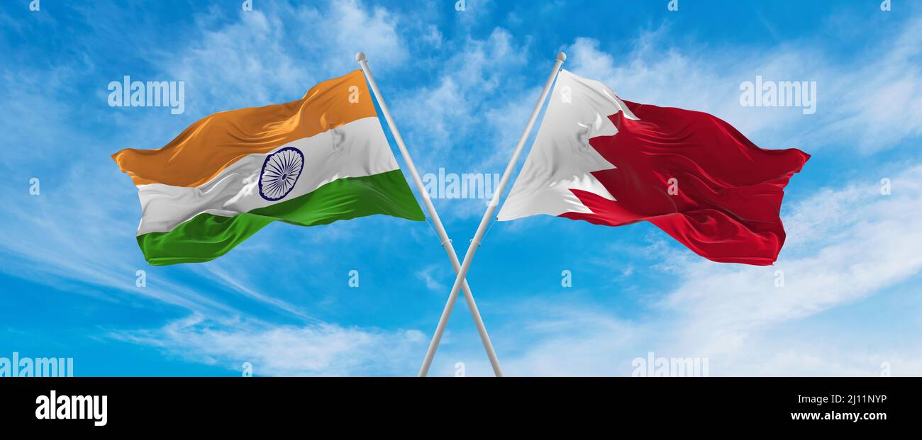 crossed national flags of India and Bahrain flag waving in the wind at ...