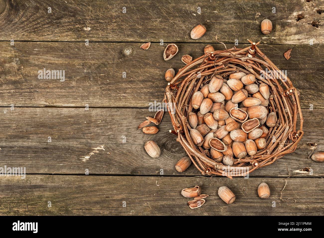 Ripe hazelnuts in shells. Harvest in a wicker basket, a healthy ...