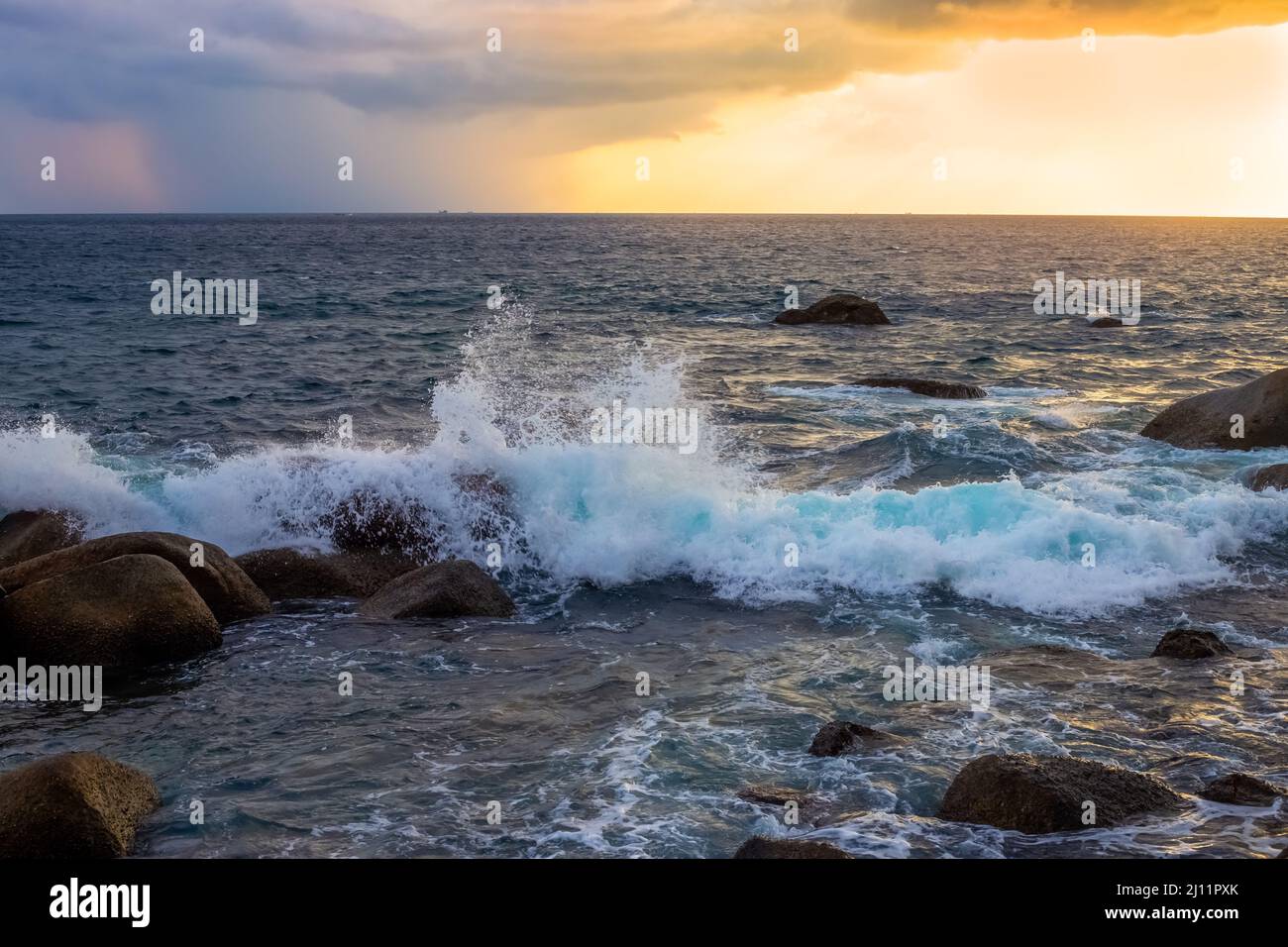 Wave crashing against rock on the beach hi-res stock photography and ...