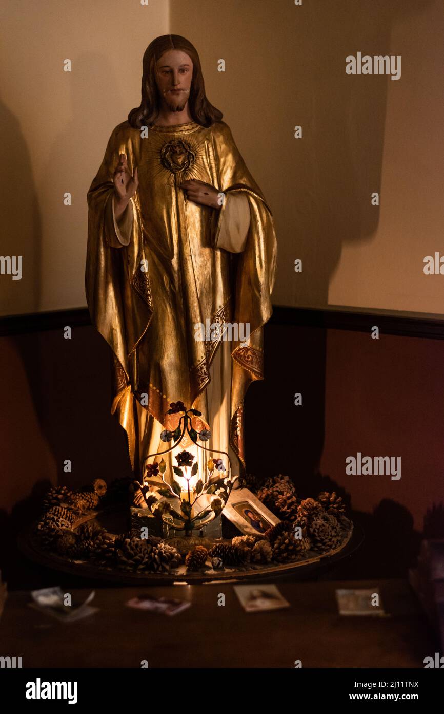 Jesus Christ statue with sacred heart adorned with pine cones and ...