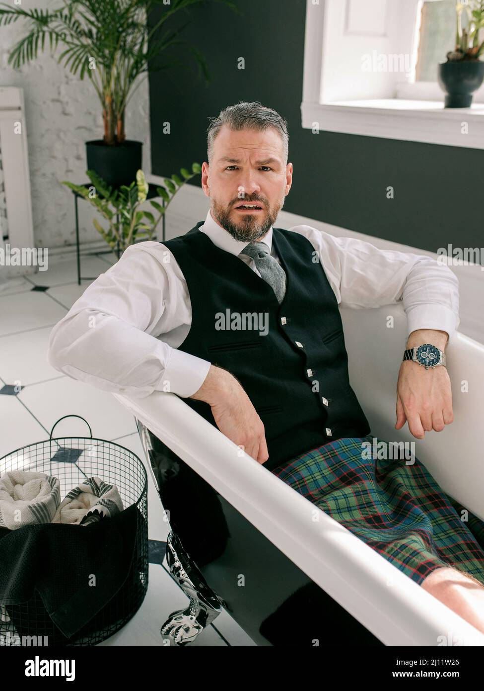 handsome mature courageous stylish man scotsman in kilt and suit laying ...
