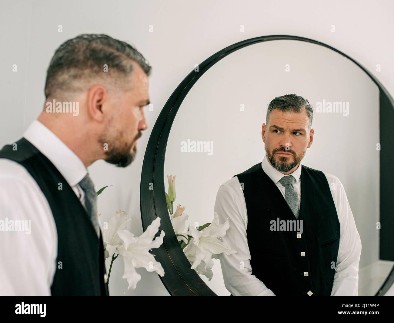 handsome mature courageous stylish man scotsman in suit by the mirror ...