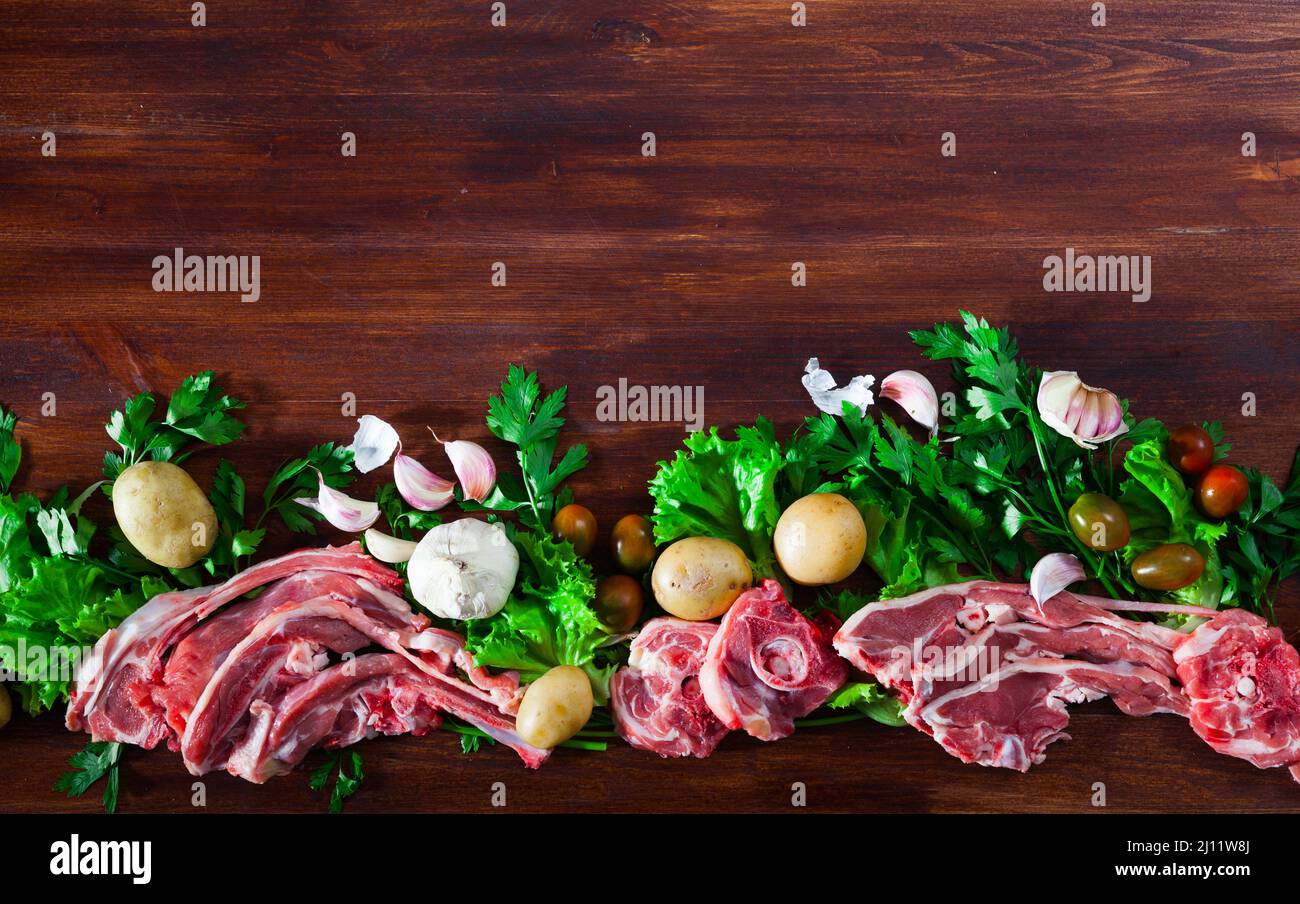 Raw mutton and vegetables assortment on natural wooden background Stock ...