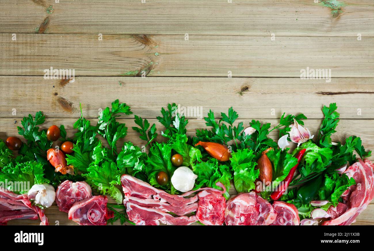 Raw mutton and vegetables assortment on natural wooden background Stock ...
