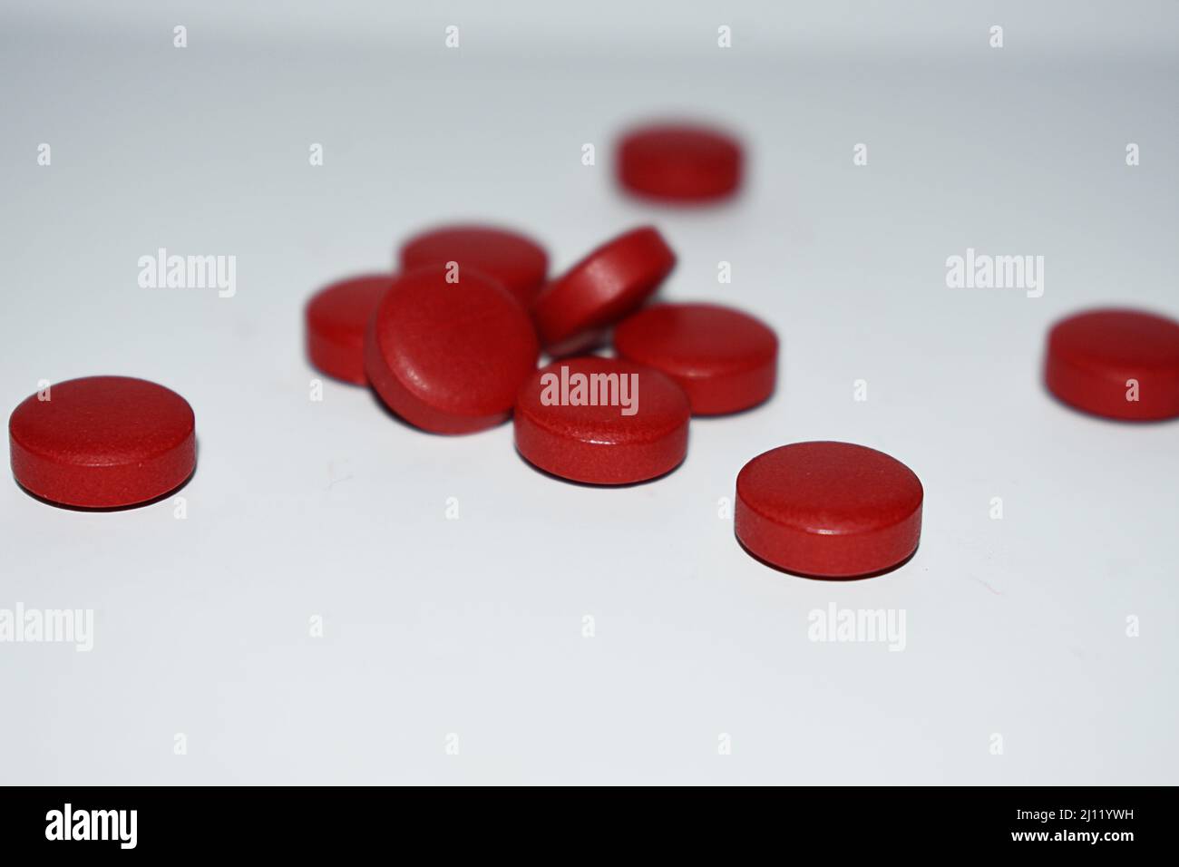 red pills on white background Stock Photo - Alamy
