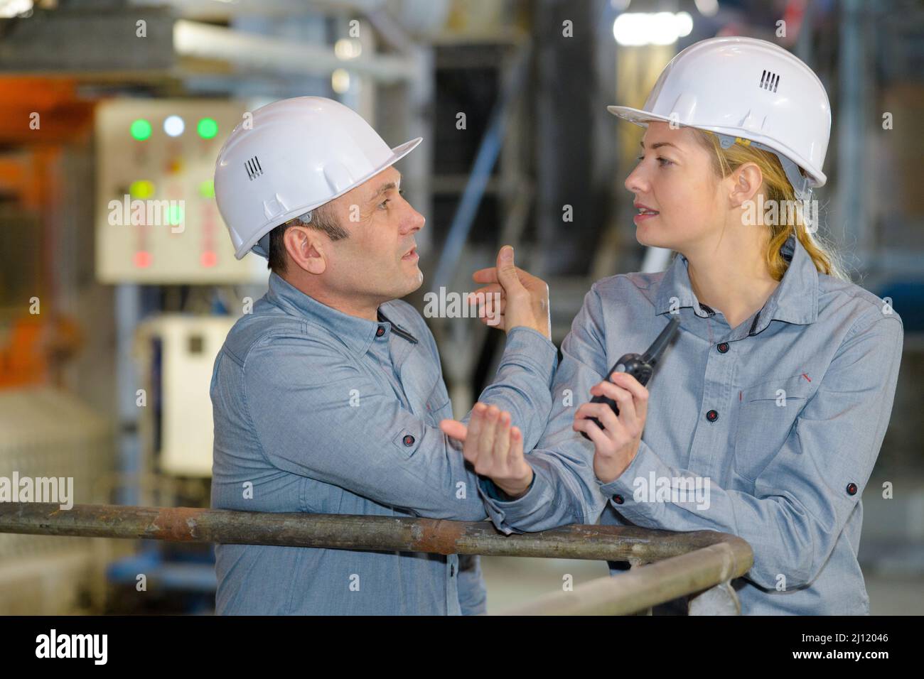 portrait of two mechanics talking Stock Photo - Alamy