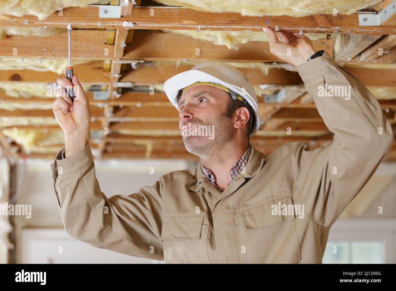 construction worker assemble a suspended ceiling Stock Photo - Alamy