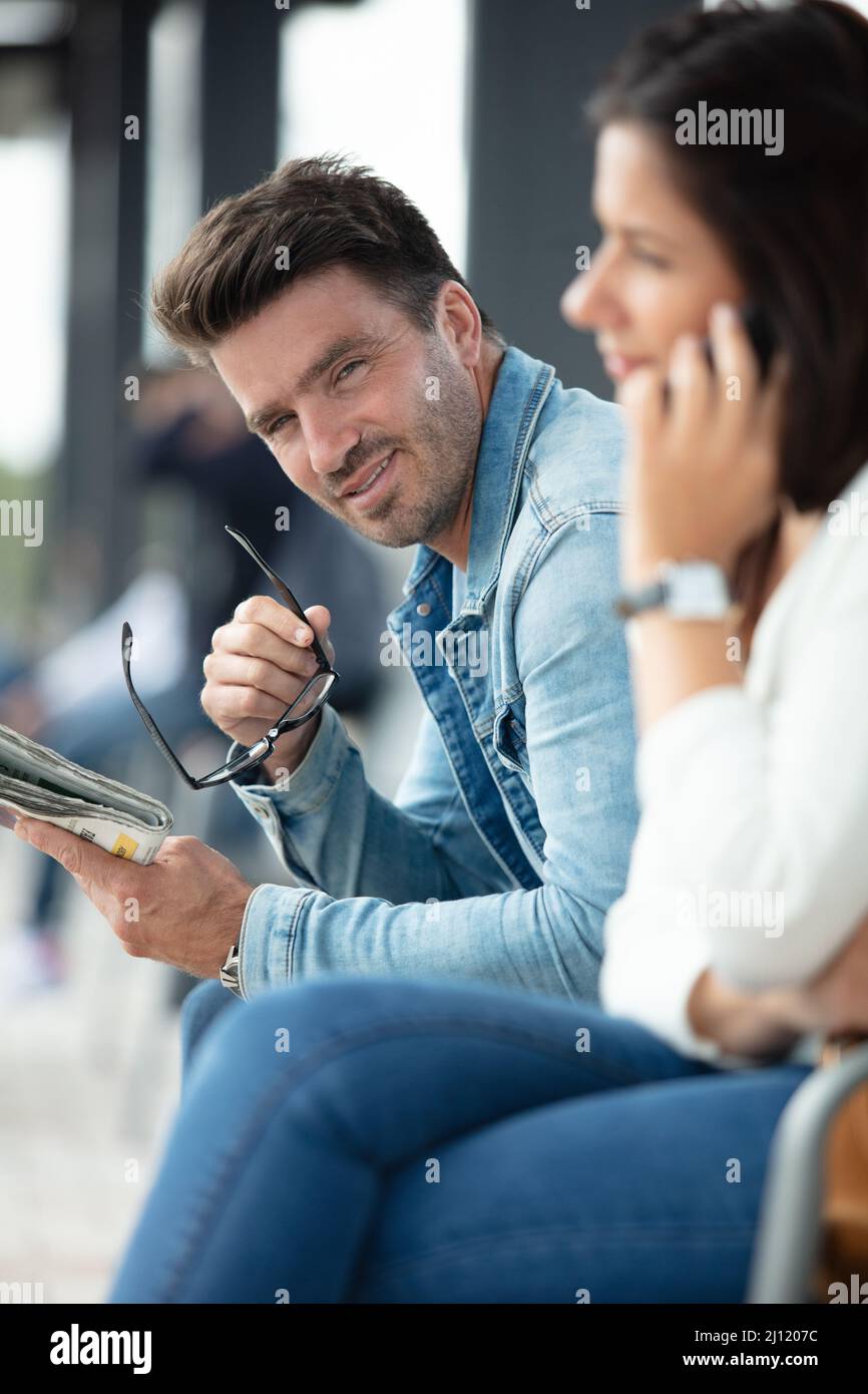 handsome man waiting his bus at bus stop Stock Photo - Alamy