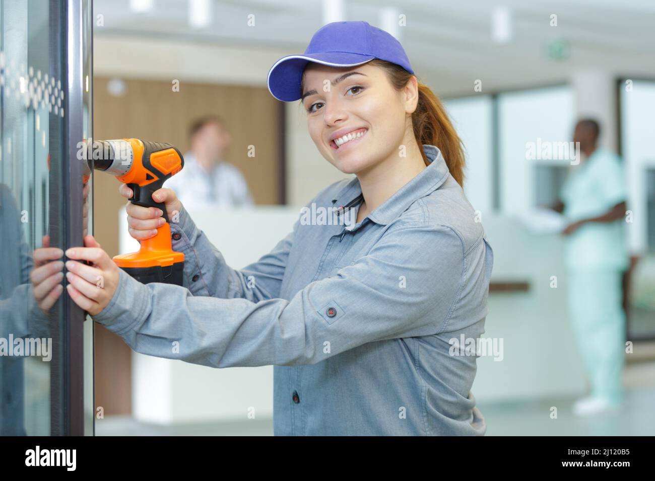 Young woman using drill machine hi-res stock photography and images - Alamy