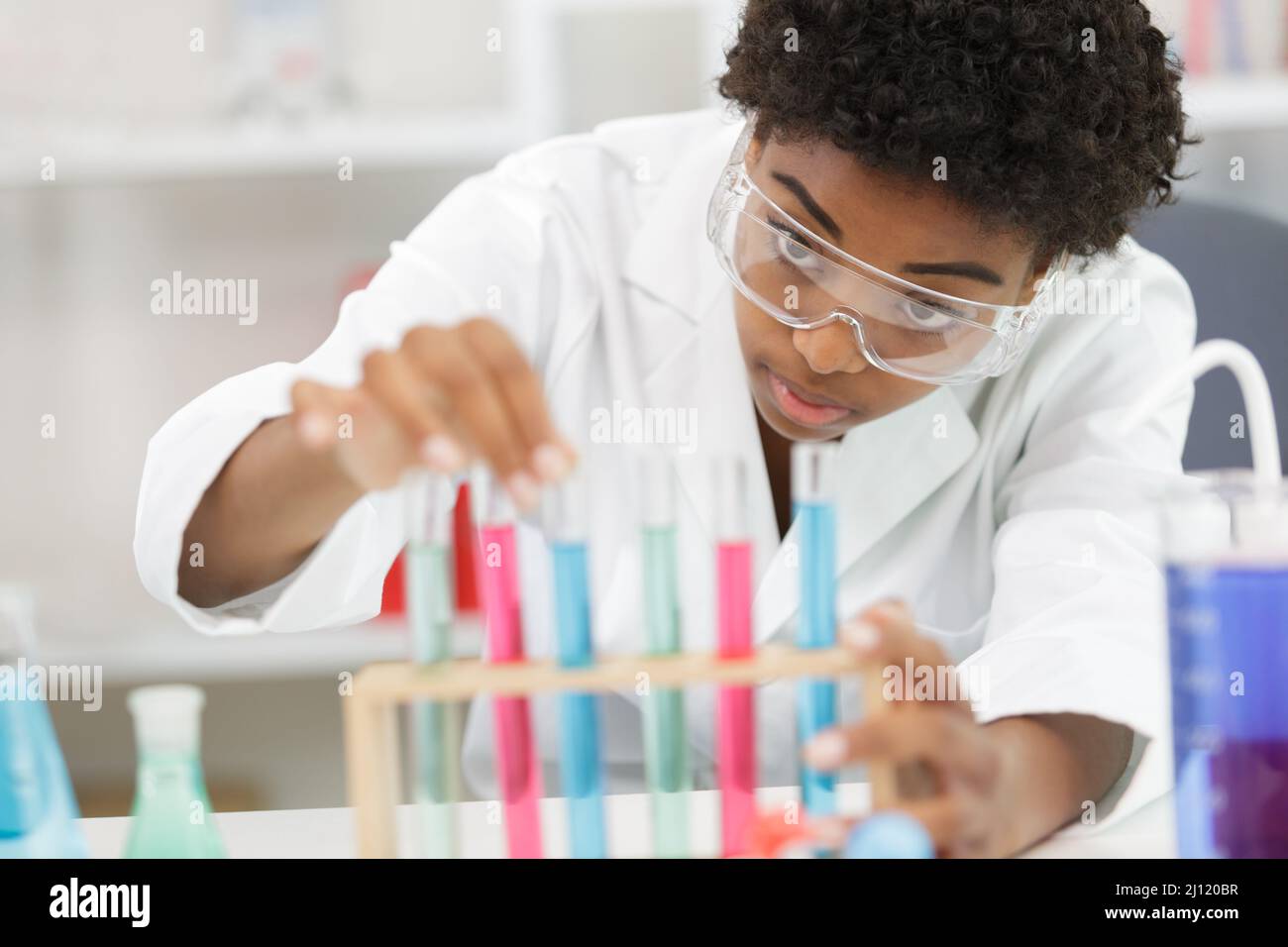 female scientist examining samples in test tube rack Stock Photo - Alamy