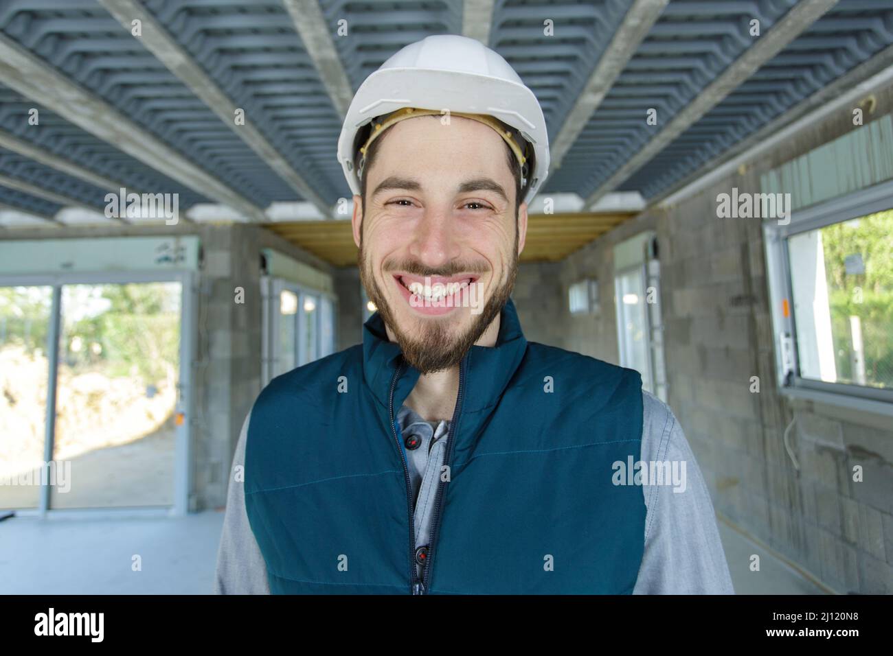 smiling builder worker in orange protectiive cask isolated on white ...