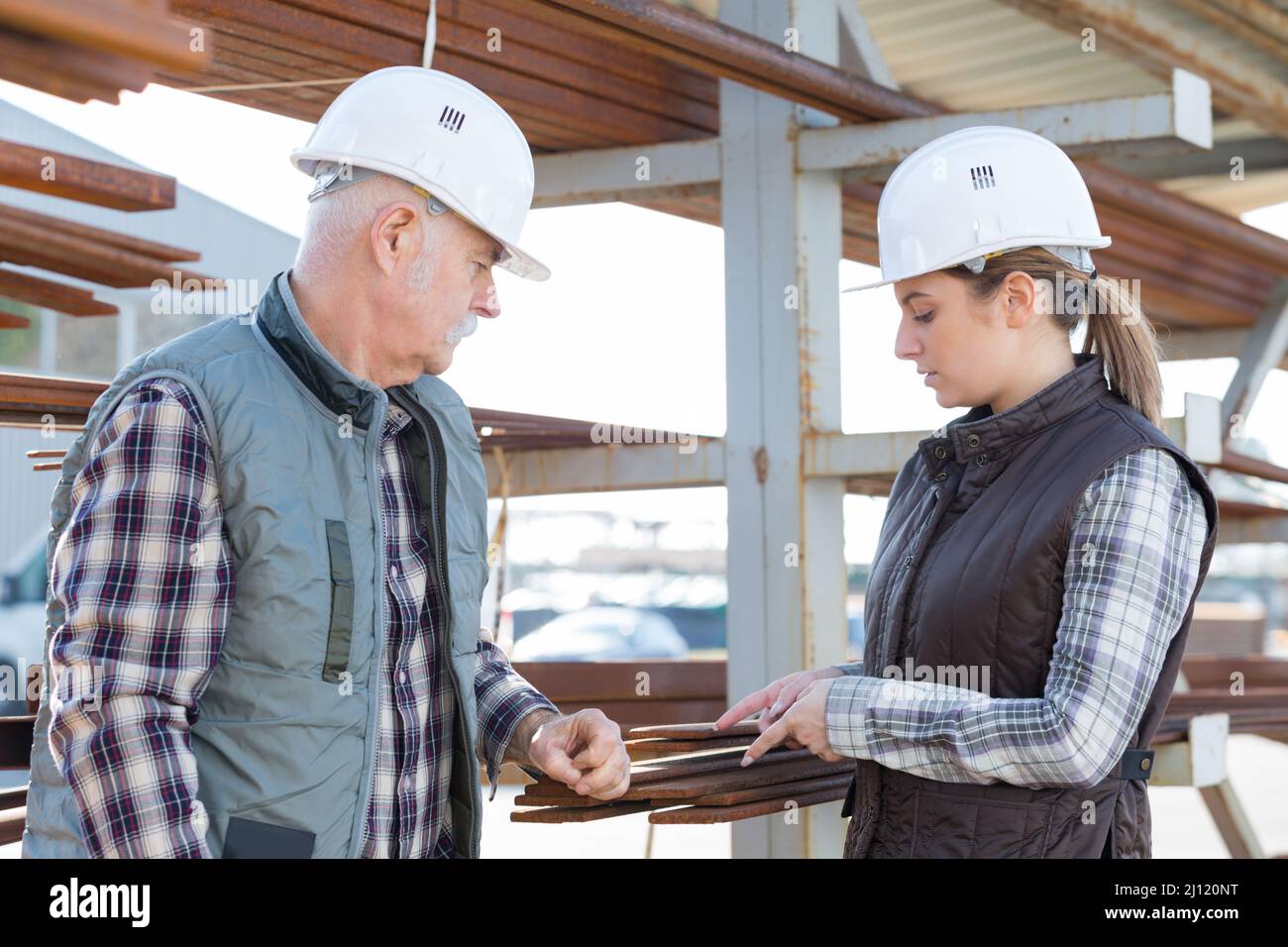 Male female civil engineers examining hi-res stock photography and ...