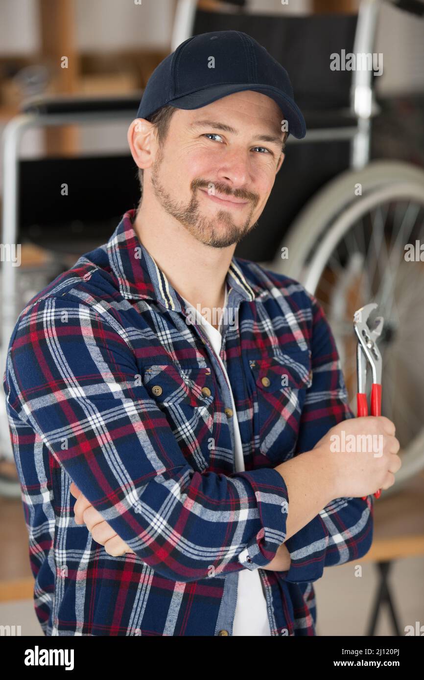 man is fixing a wheelchair Stock Photo - Alamy