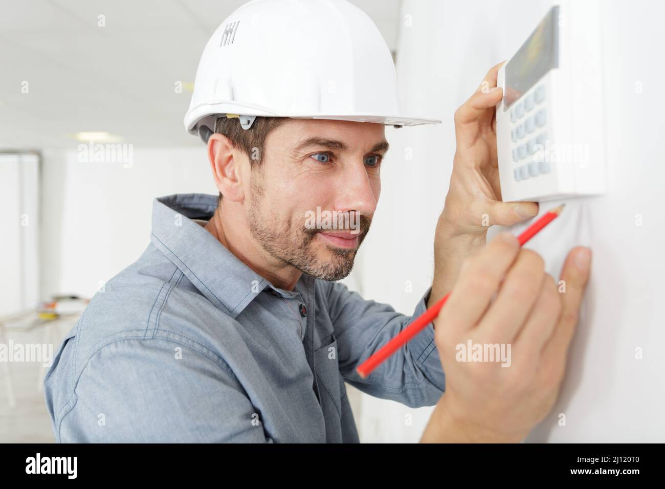 man drawing next to a box with a pencil Stock Photo - Alamy