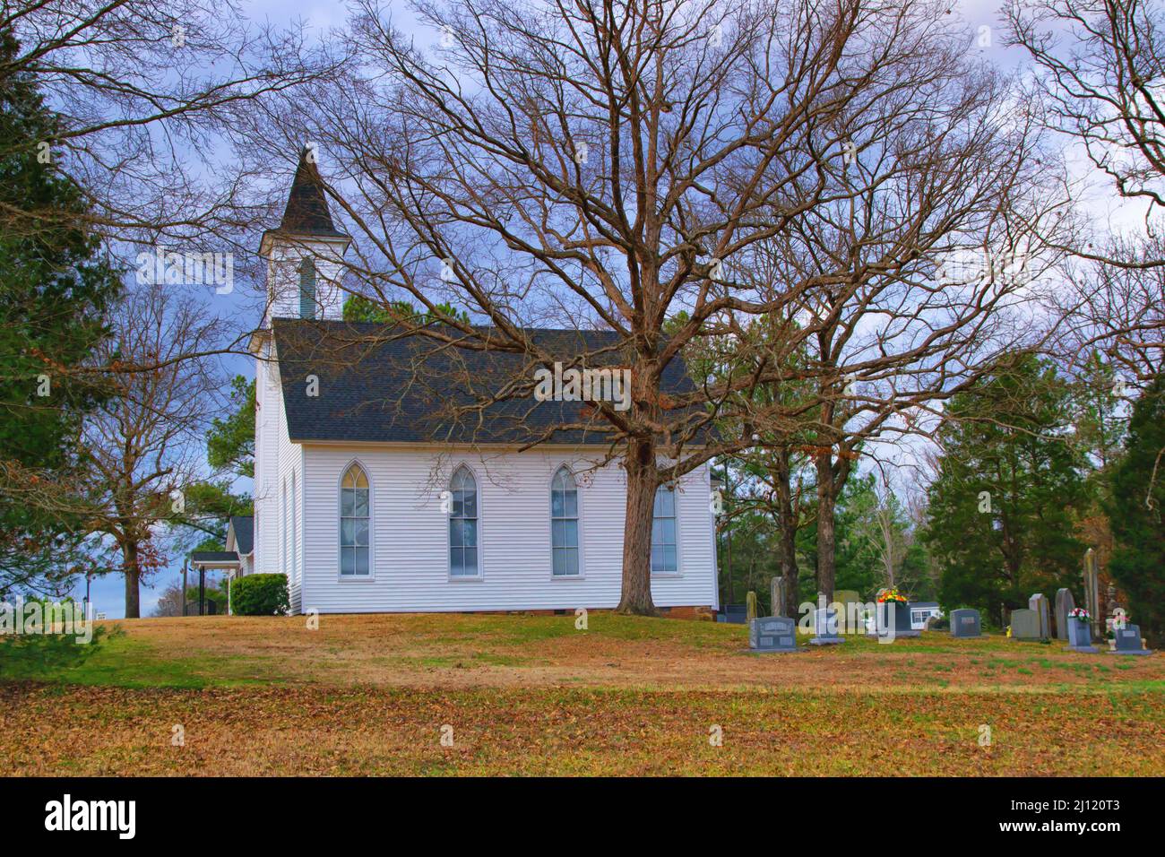 Small church next to a graveyard under the bright sunlight Stock Photo ...
