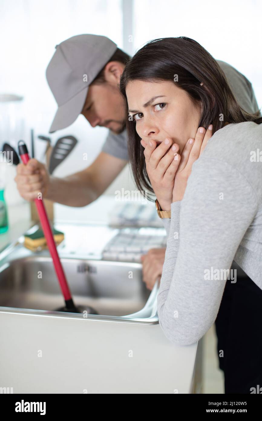 sad young woman in blocked kitchen sink at home Stock Photo - Alamy