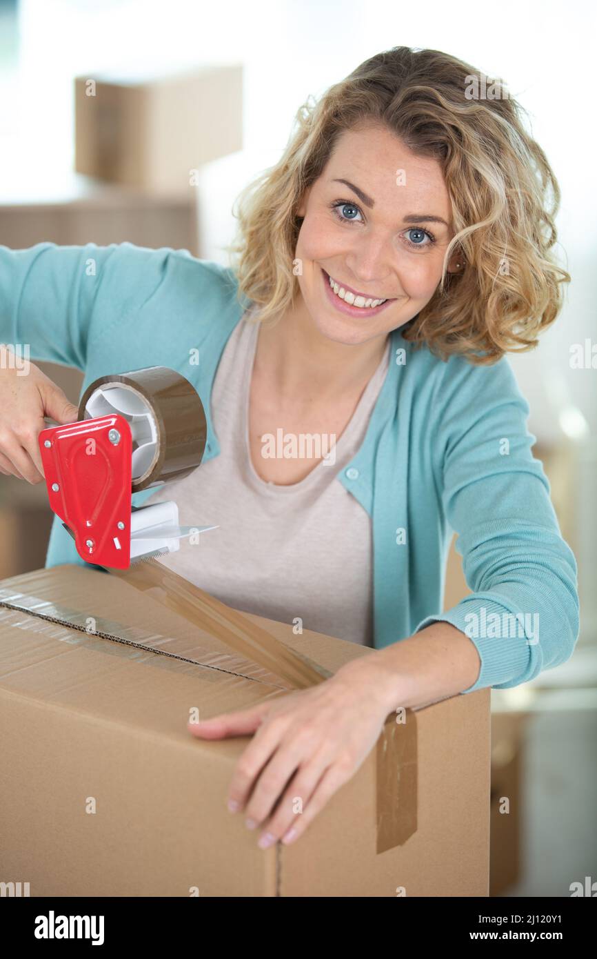 close-up of female sealing cardboard box with adhesive tape Stock Photo ...