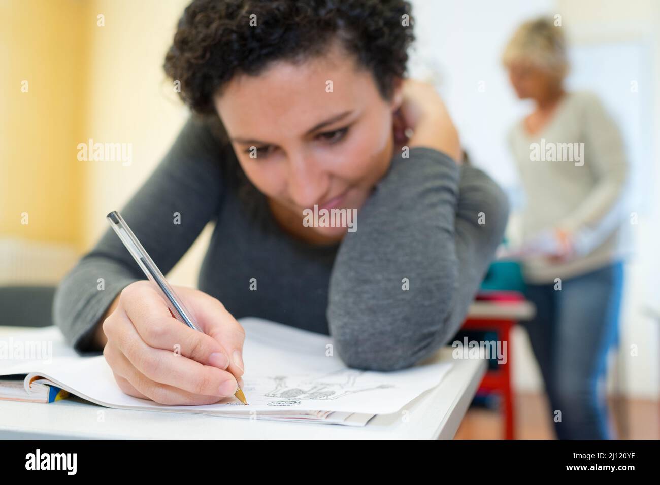 student girl writing test in classroom Stock Photo - Alamy