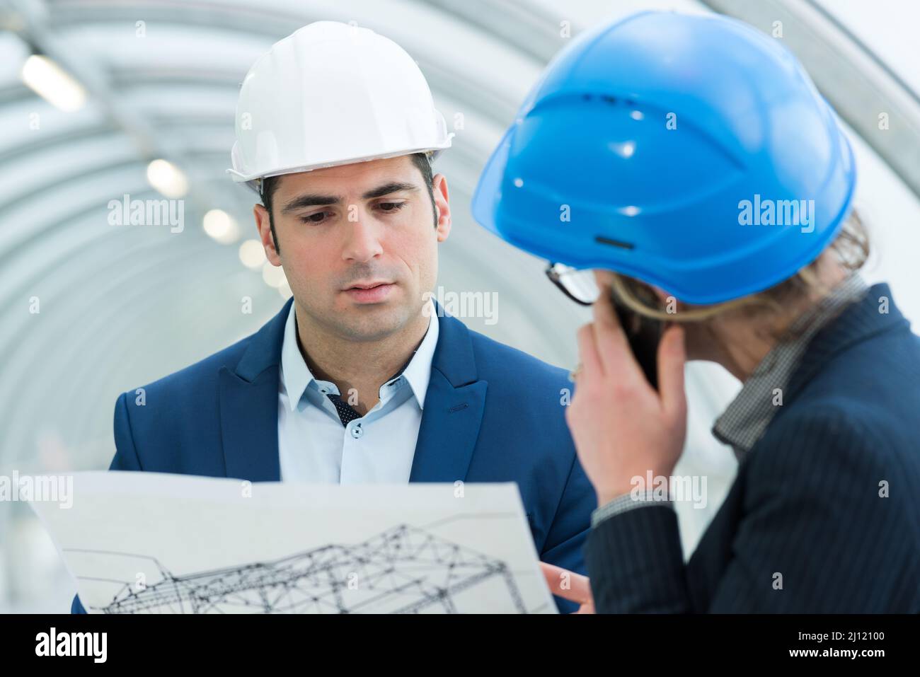 engineer in a construction site looking at plans Stock Photo - Alamy