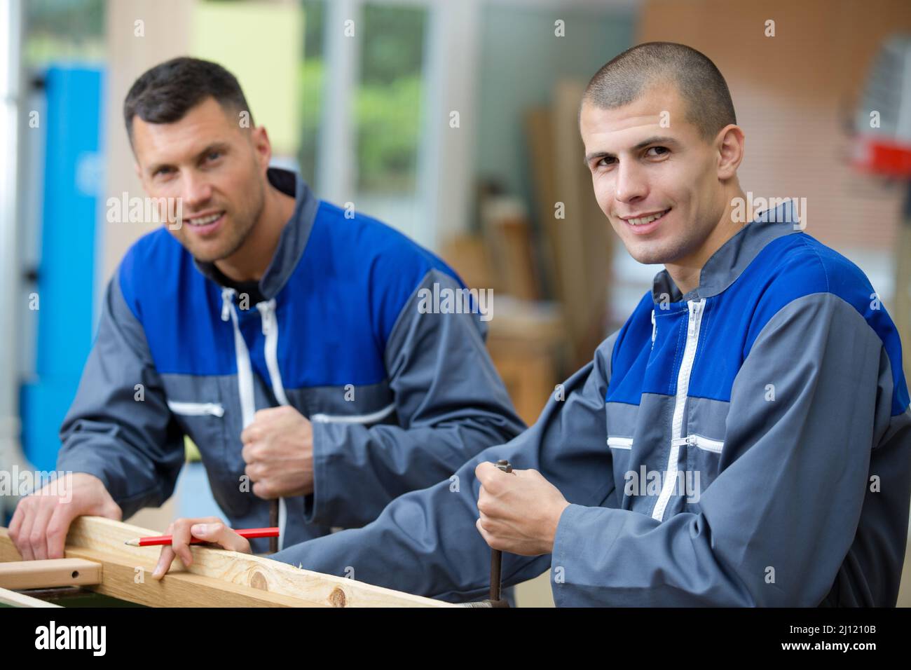 two carpenters working on design Stock Photo - Alamy