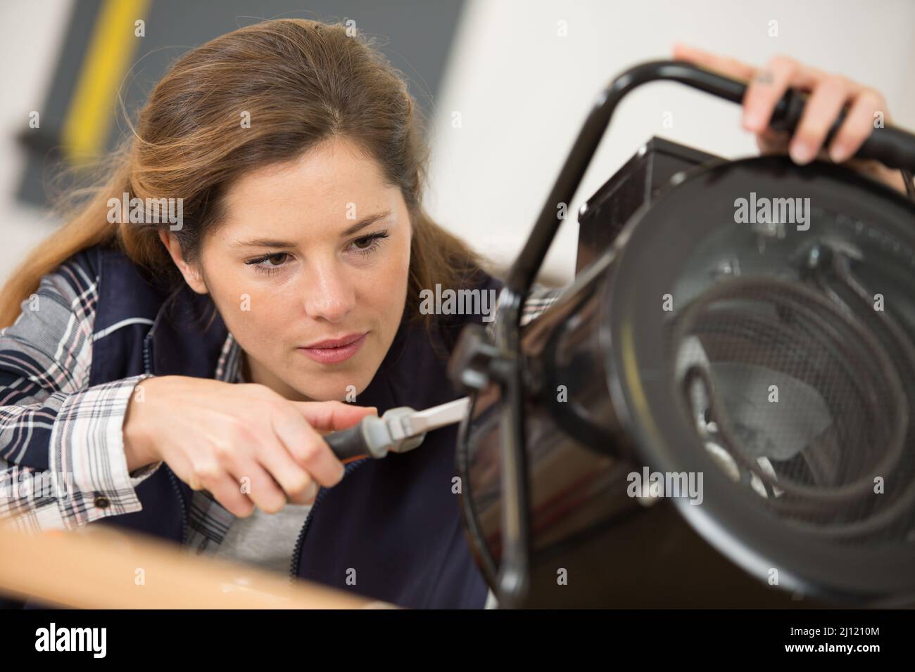 female worker repairing electrical appliance Stock Photo - Alamy
