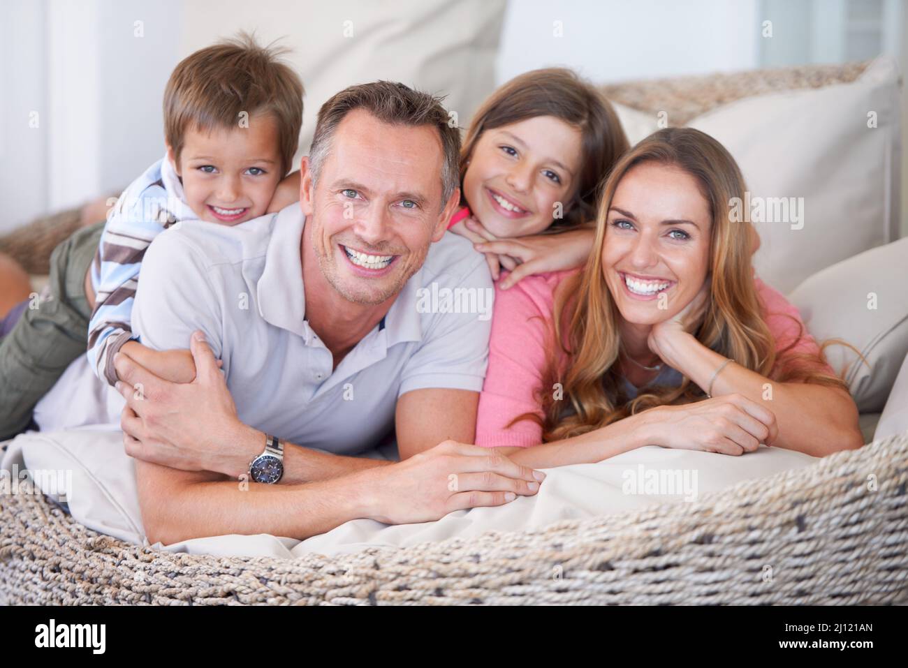 Relaxing with the family. Portrait of a happy young family of four ...