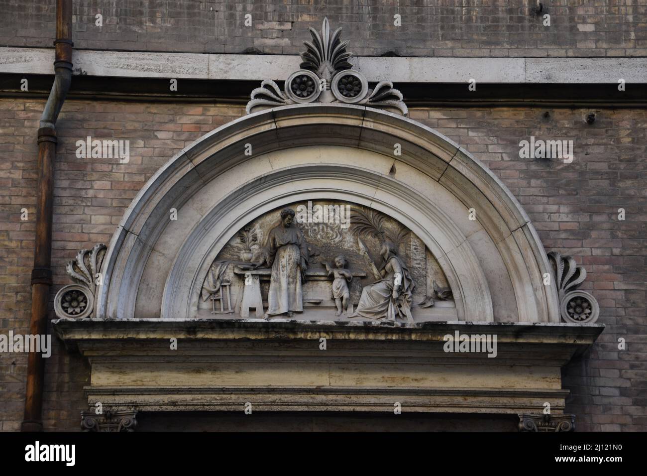 Stone carving above a doorway depicting a man, woman, and child. Rome ...