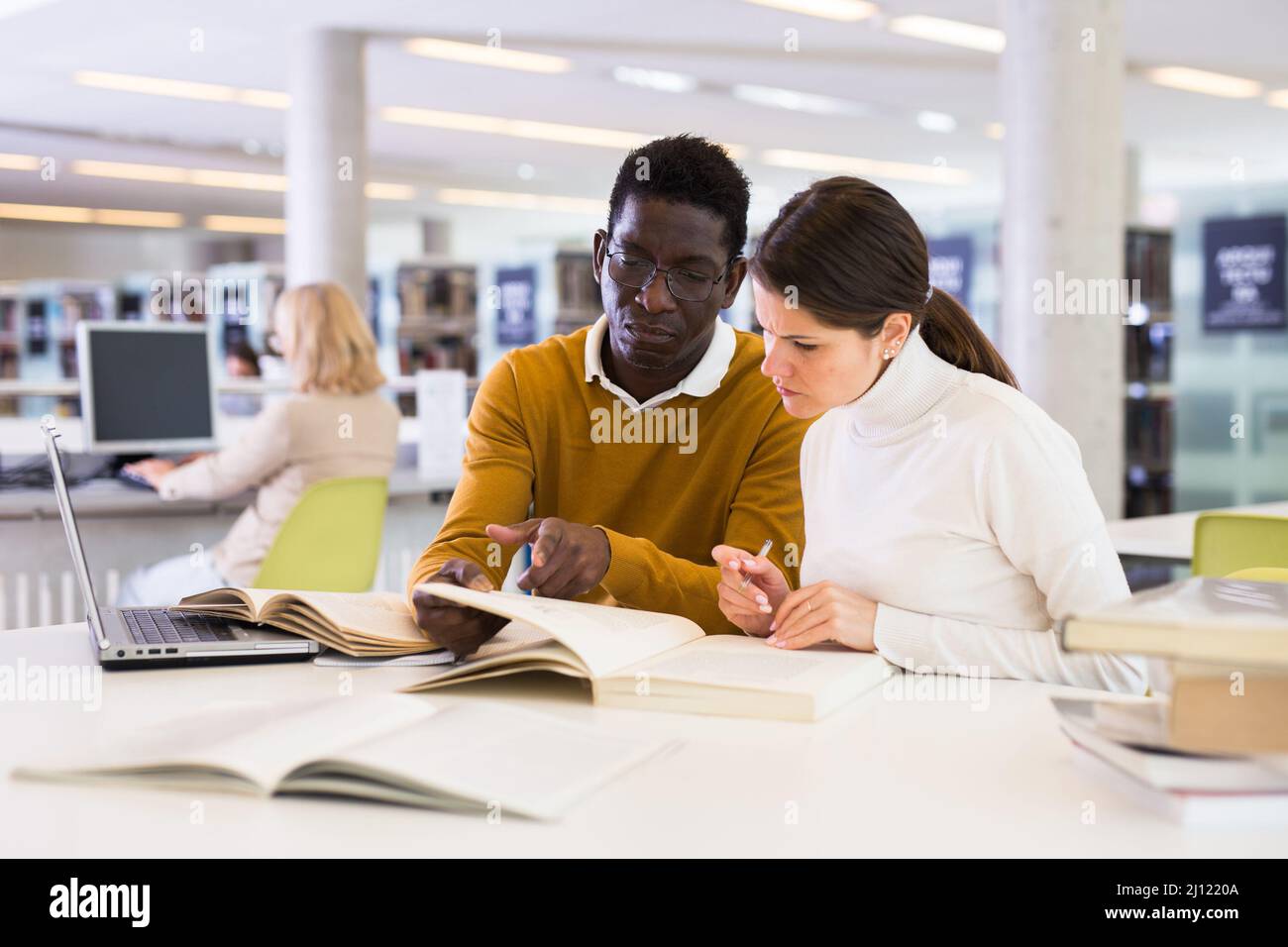 People reading and making notes while preparing for exam in library ...