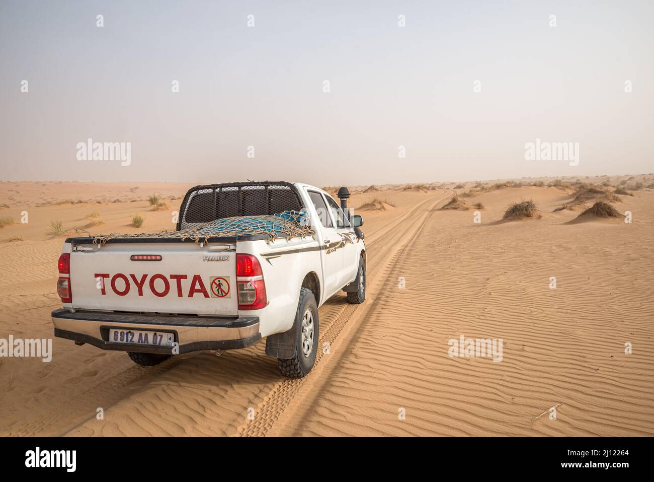 A Toyota 4x4 pick-up on a sandy track in the middle of Sahara desert ...