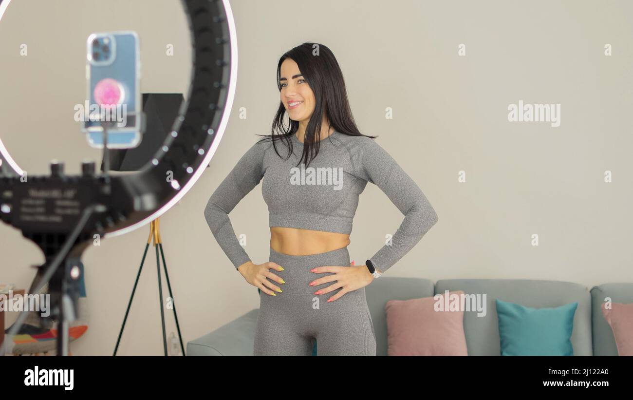 Virtual online fitness. Woman virtual workout at home living room Stock ...