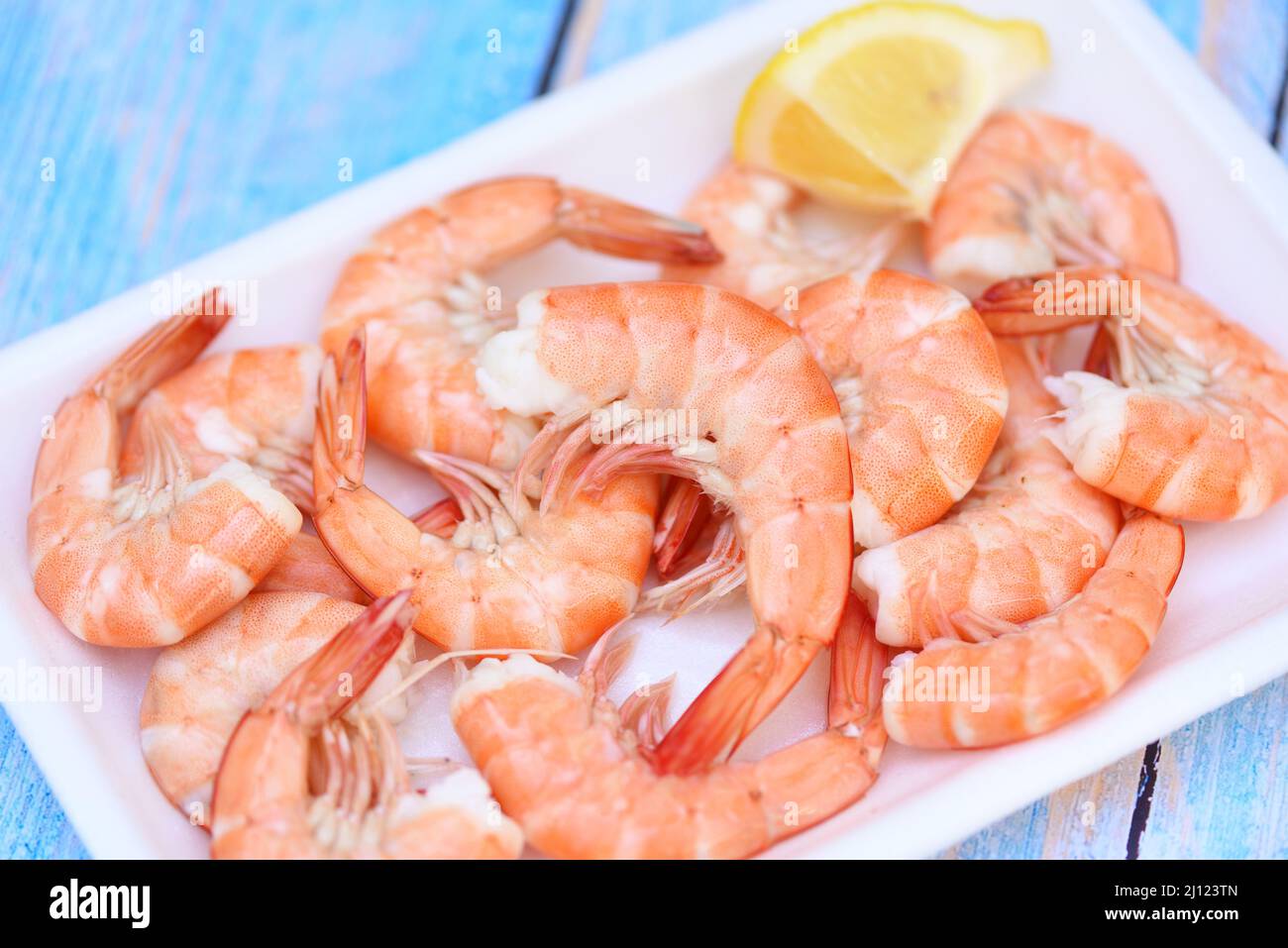 Fresh shrimps on on plate plastic tray with lemon, boiled shrimp prawns ...