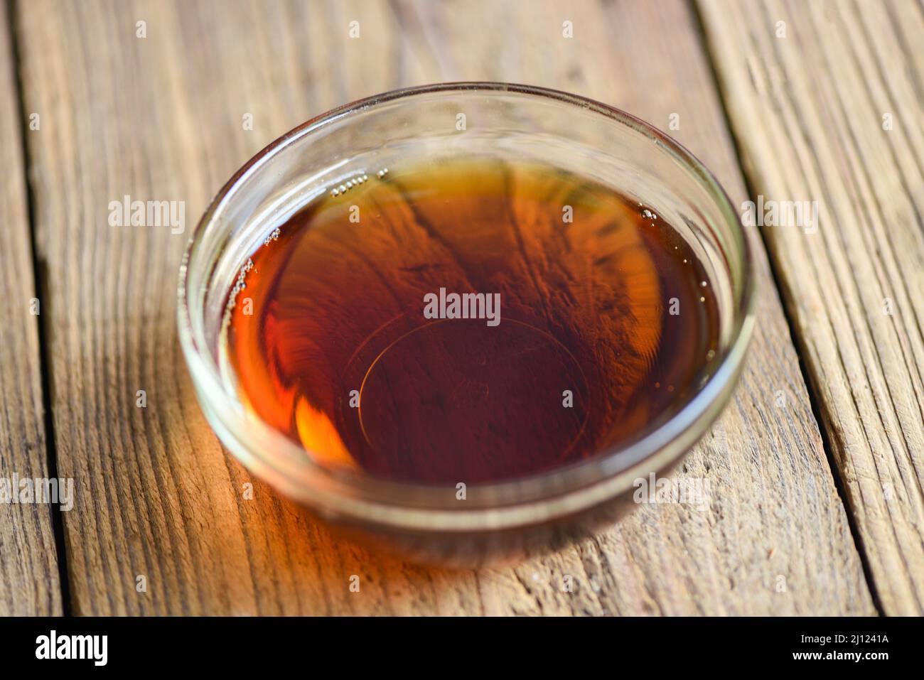 fish sauce on glass bowl and wooden background, fish sauce obtained ...