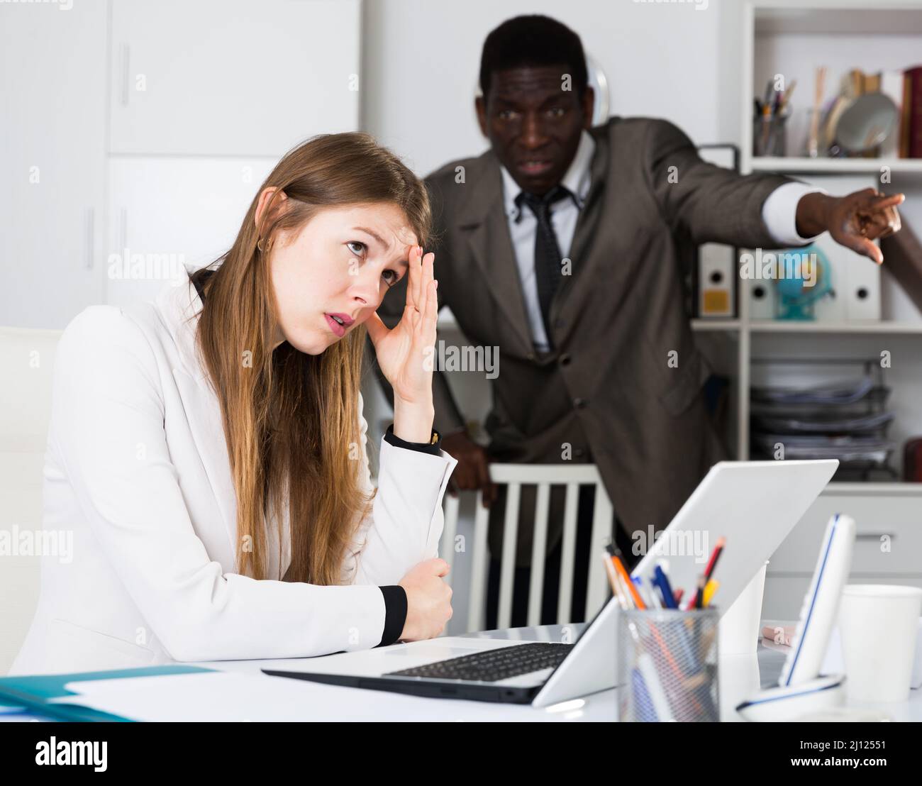 Angry male boss screaming to young female manager during working Stock ...