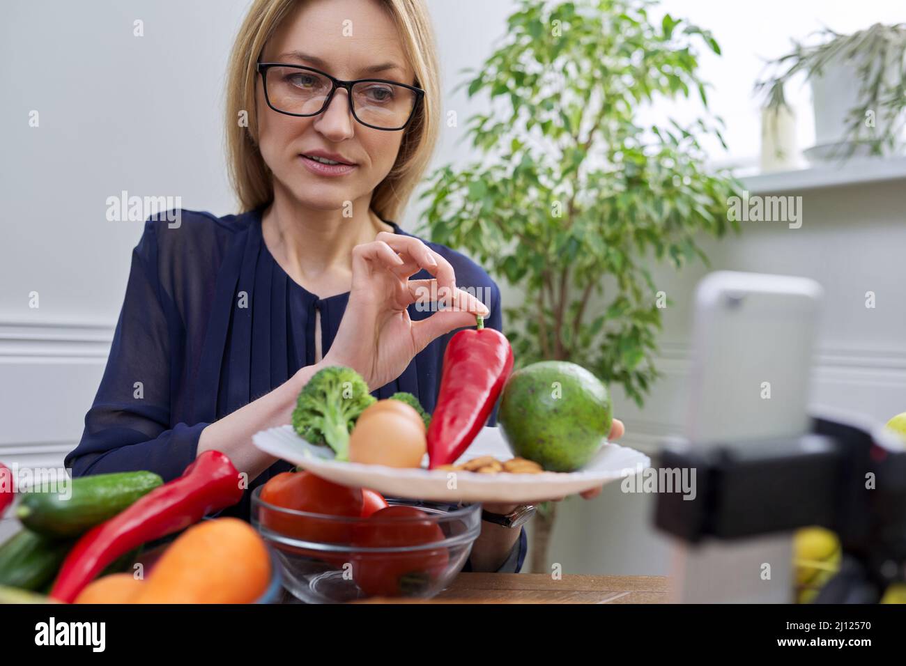 Woman telling and showing healthy food, vegetables fruits nuts eggs ...