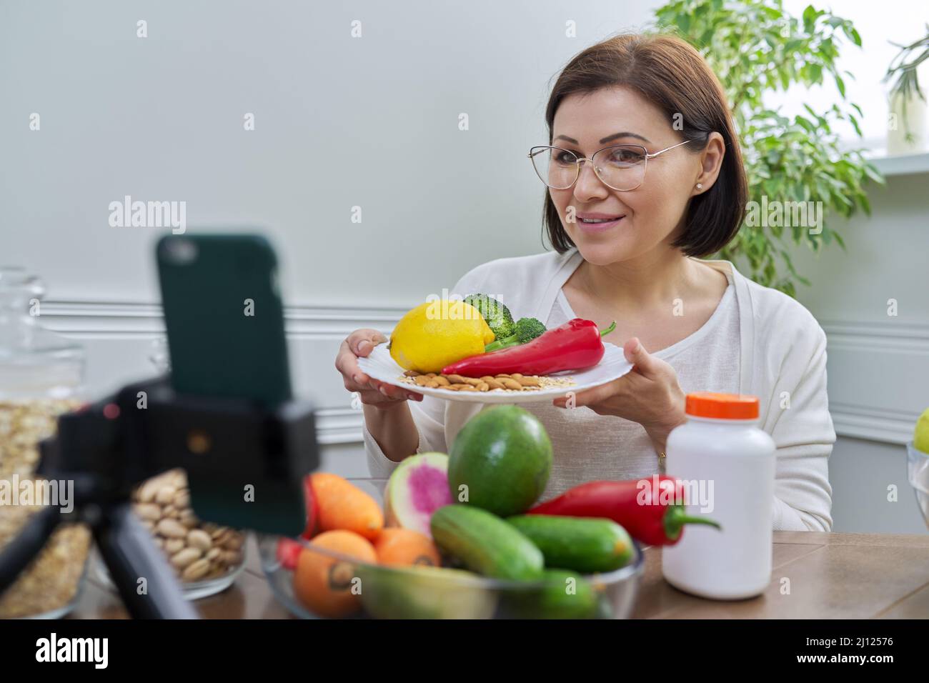 Woman recording video stream about healthy eating, vitamins ...
