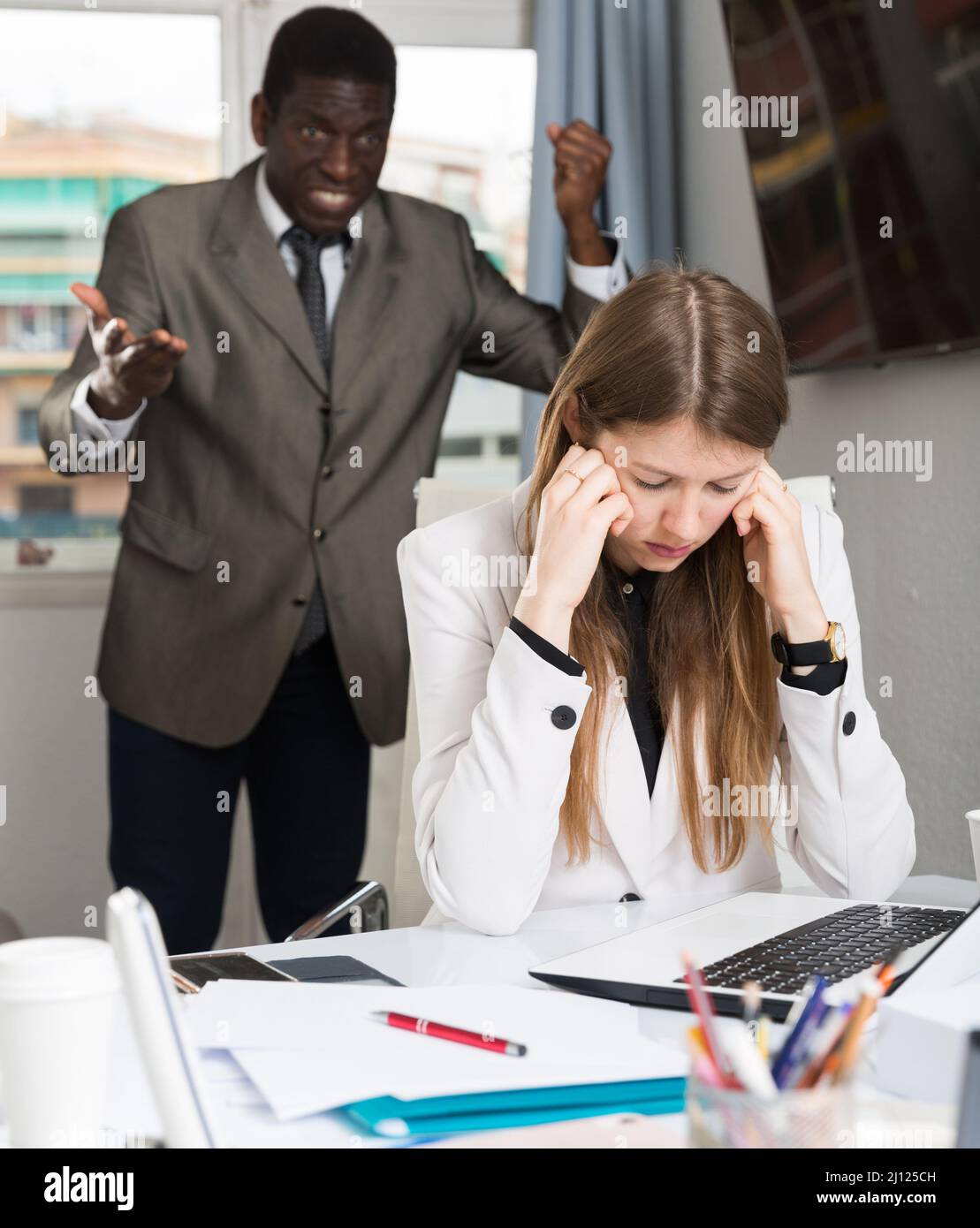 Unhappy man boss scolding mistakes in work to young female manager ...