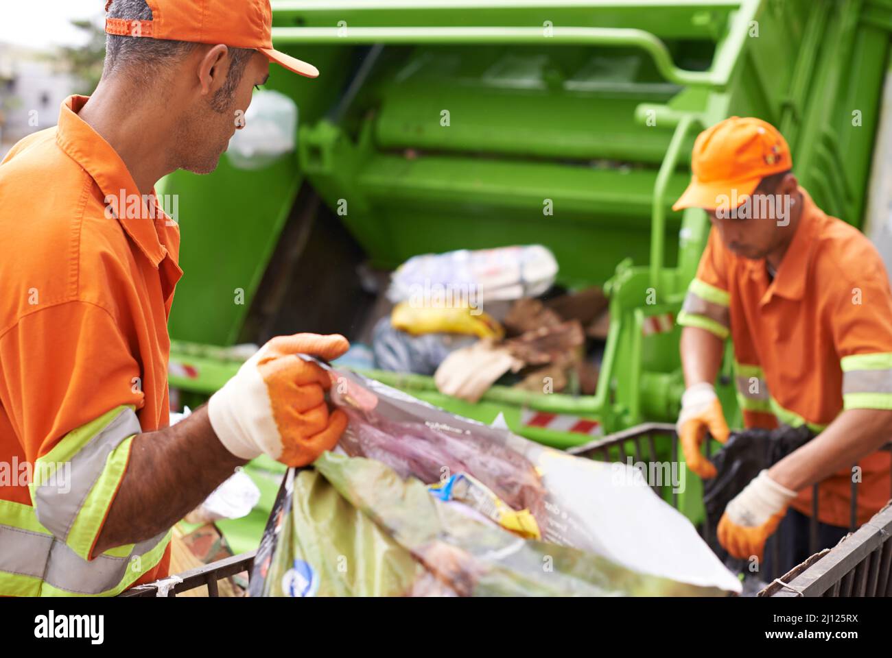 Keeping the city clean. Cropped shot of a team of garbage collectors ...