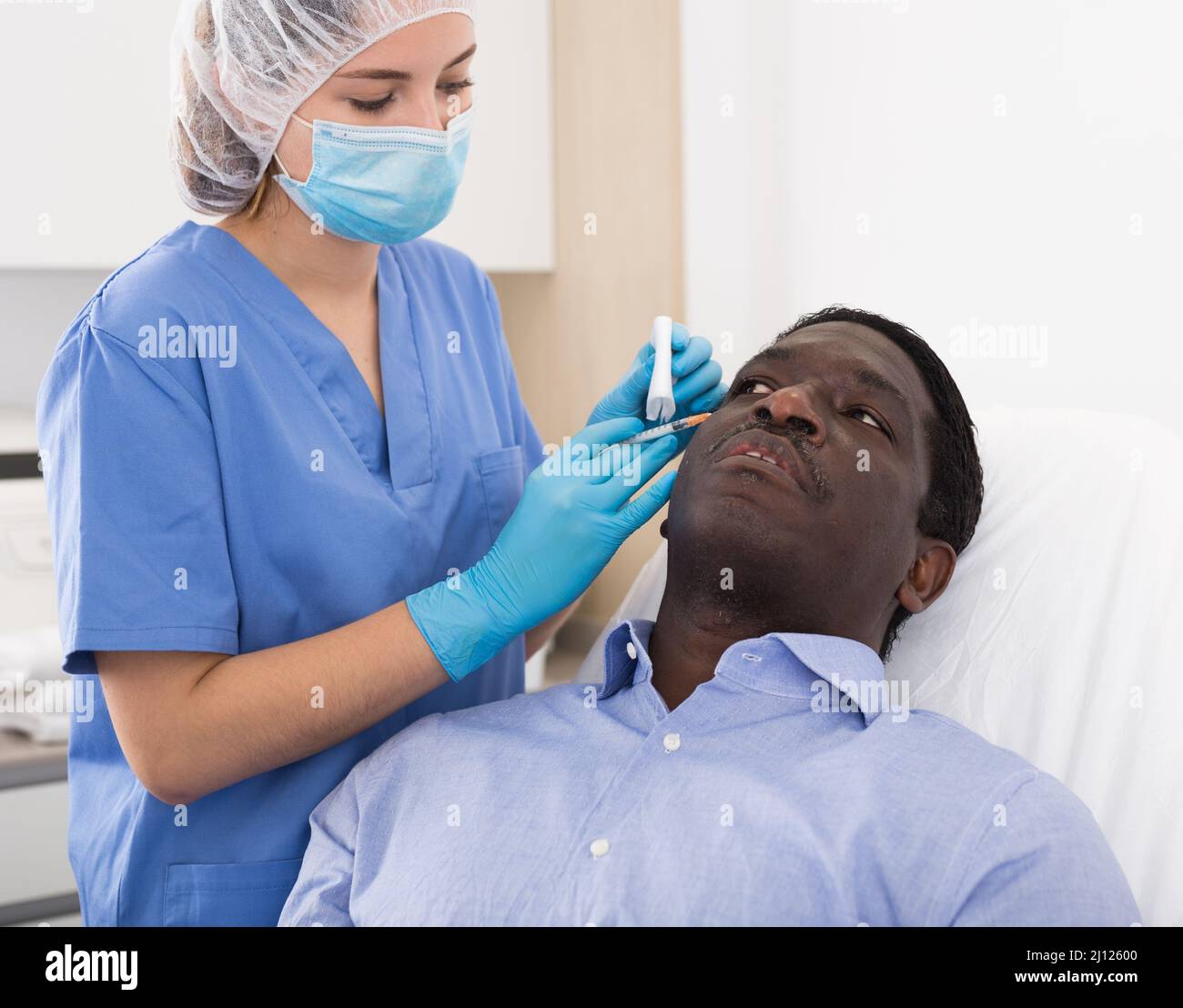 Male florist working with begonia plants Stock Photo - Alamy