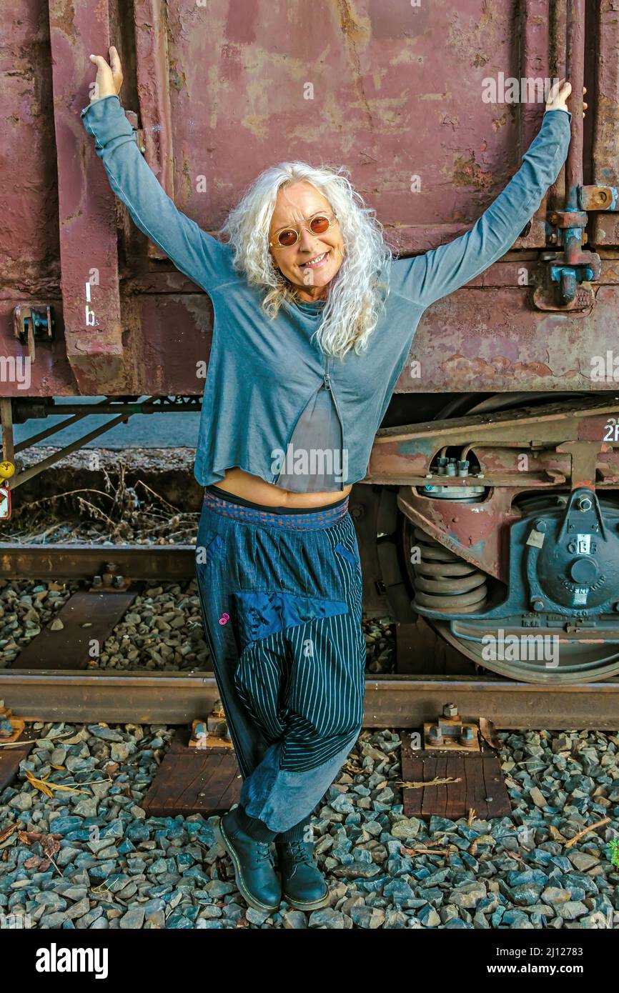 Beautiful Lady in the 50s with industry freight train in the background ...