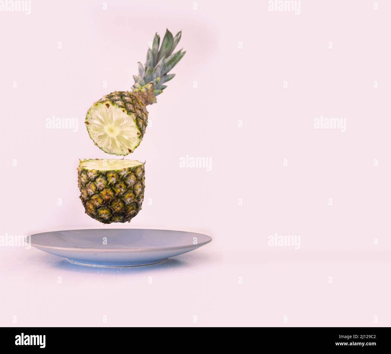 Delicious tropical fruit called pineapple sliced and levitating on a ...