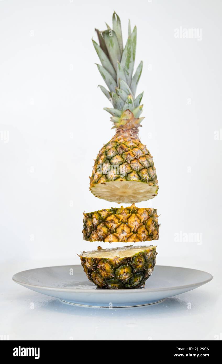 Delicious tropical fruit called pineapple sliced and levitating on a ...
