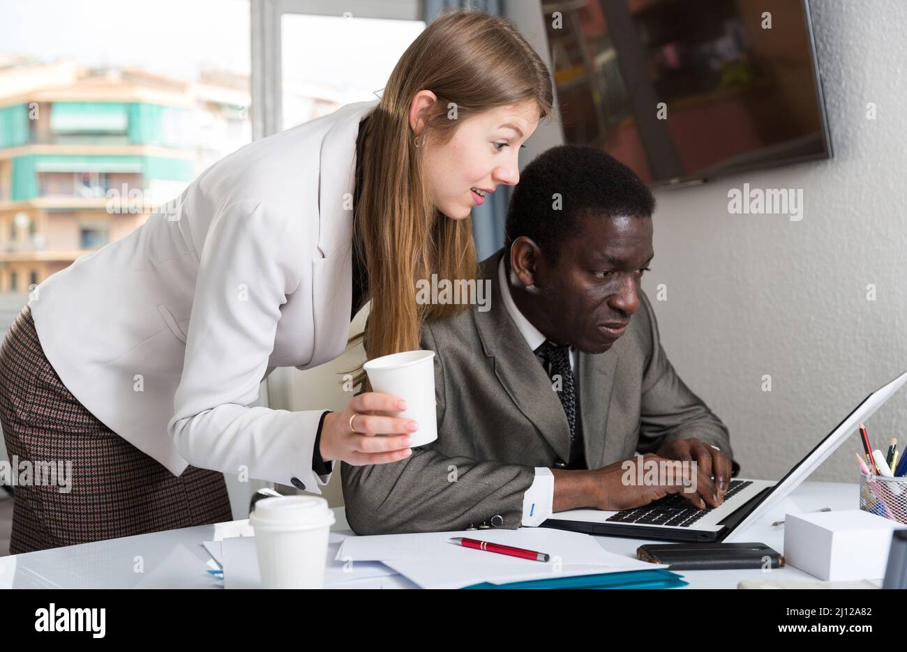 Male manager helping colleagues project hi-res stock photography and ...
