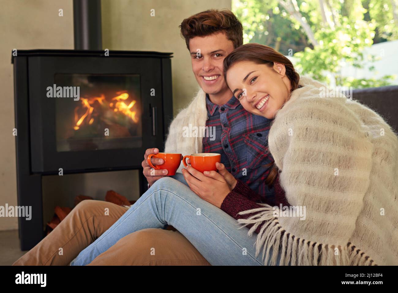 Love is friendship set on fire. Shot of a young couple drinking hot ...