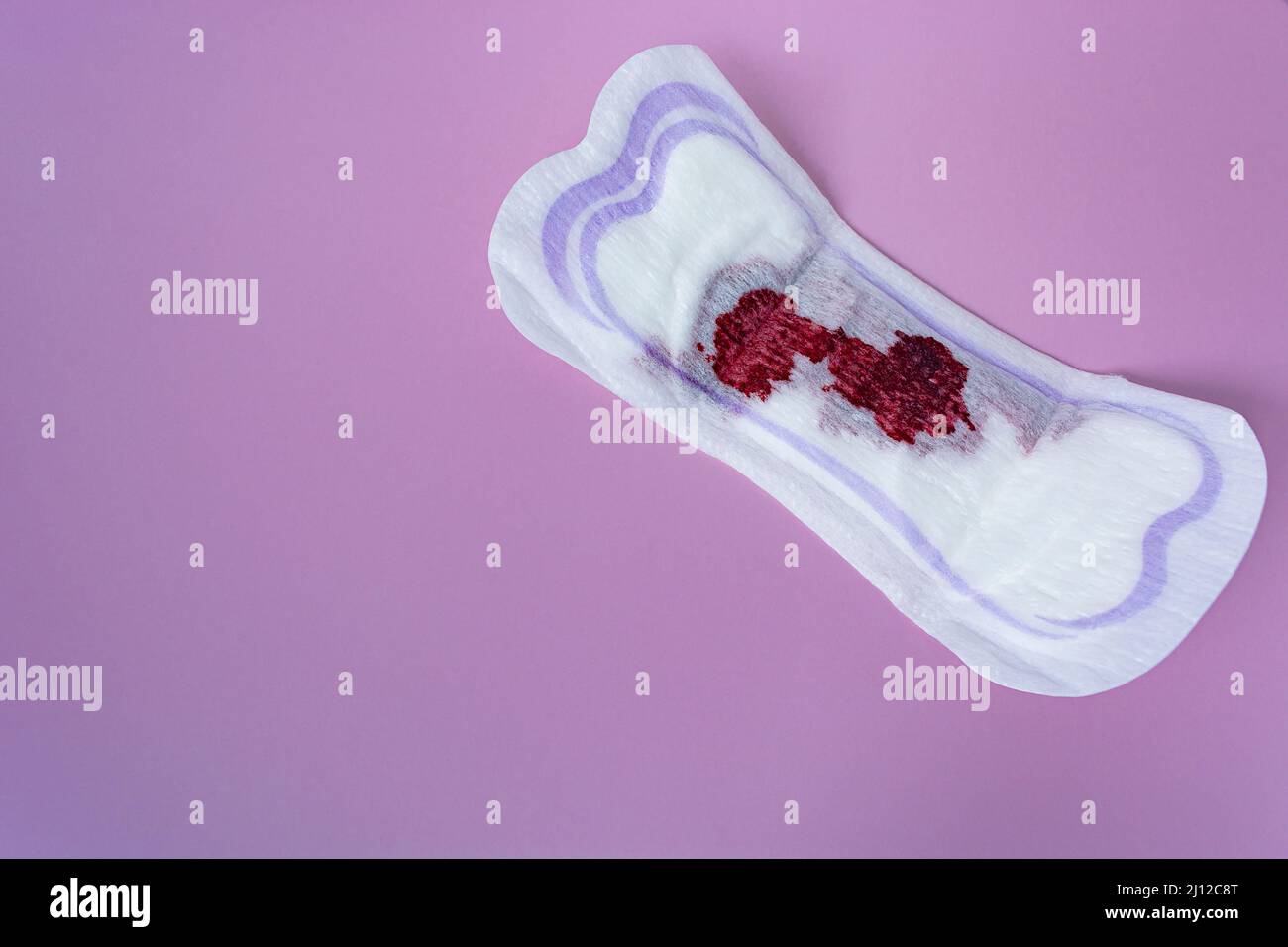 Menstrual blood on a sanitary pad on purple background. Woman hygiene ...