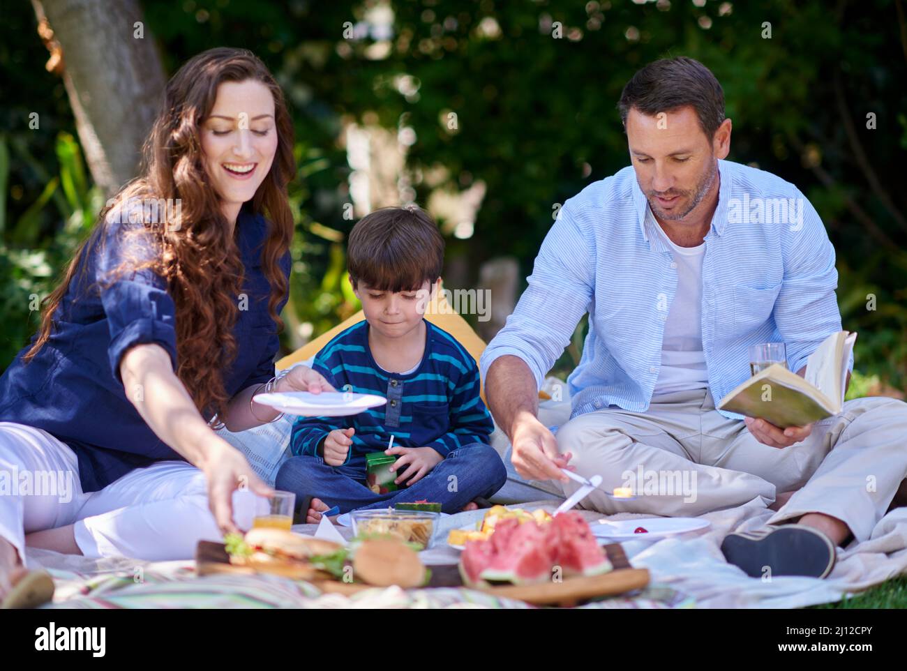 Its the perfect day for a picnic in the park. Shot of a family having a ...