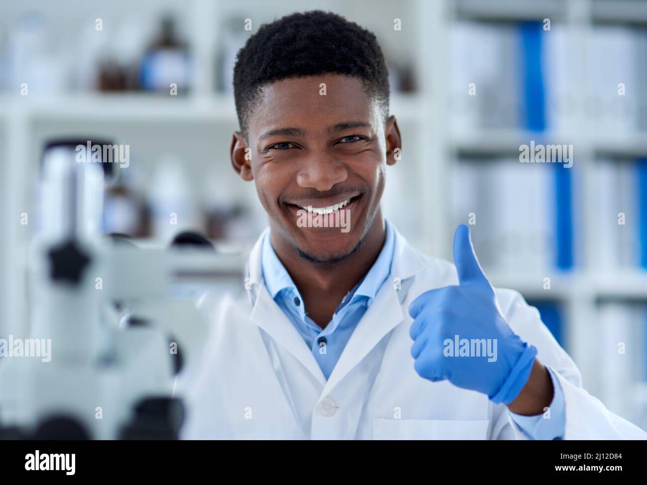 A job well done. Portrait of a cheerful young male scientist wearing ...