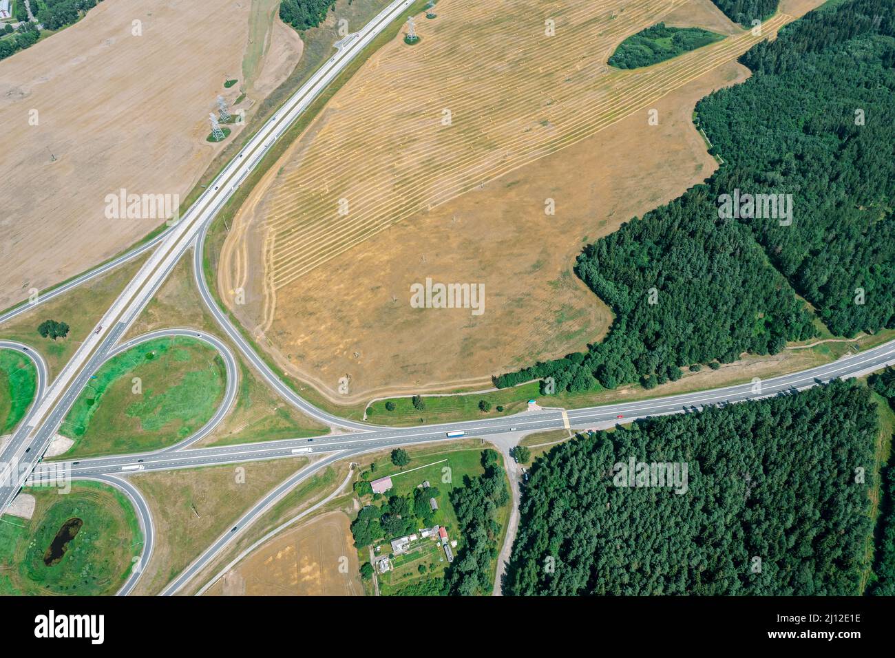 road intersection and car traffic in countryside. rural summer ...